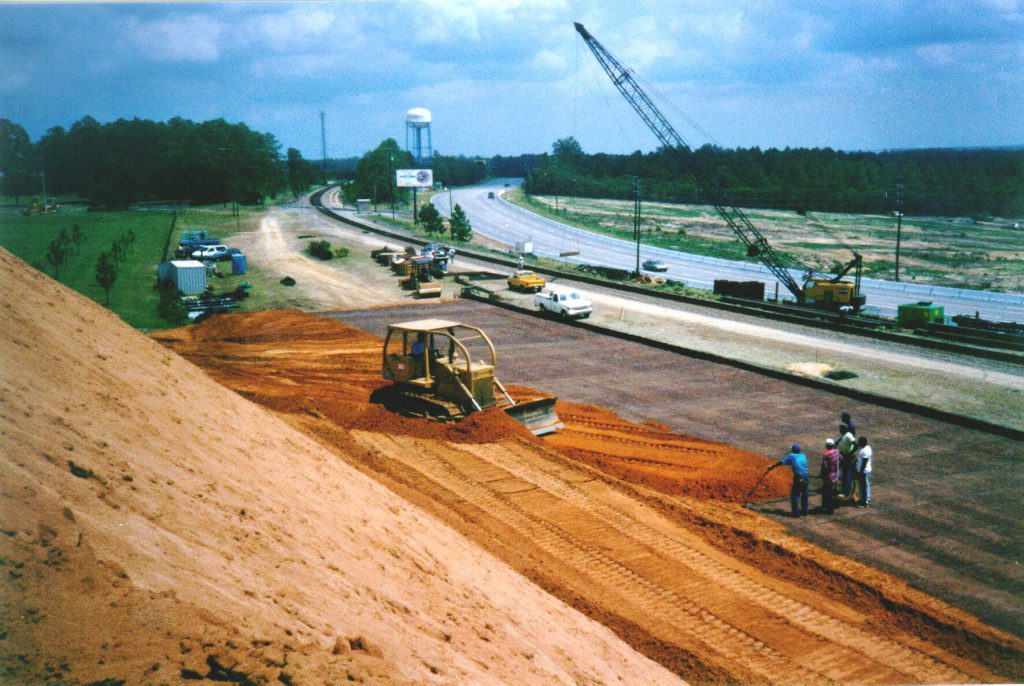 Construction of a steep soil slope near rail road tracks - STRATA GLOBAL
